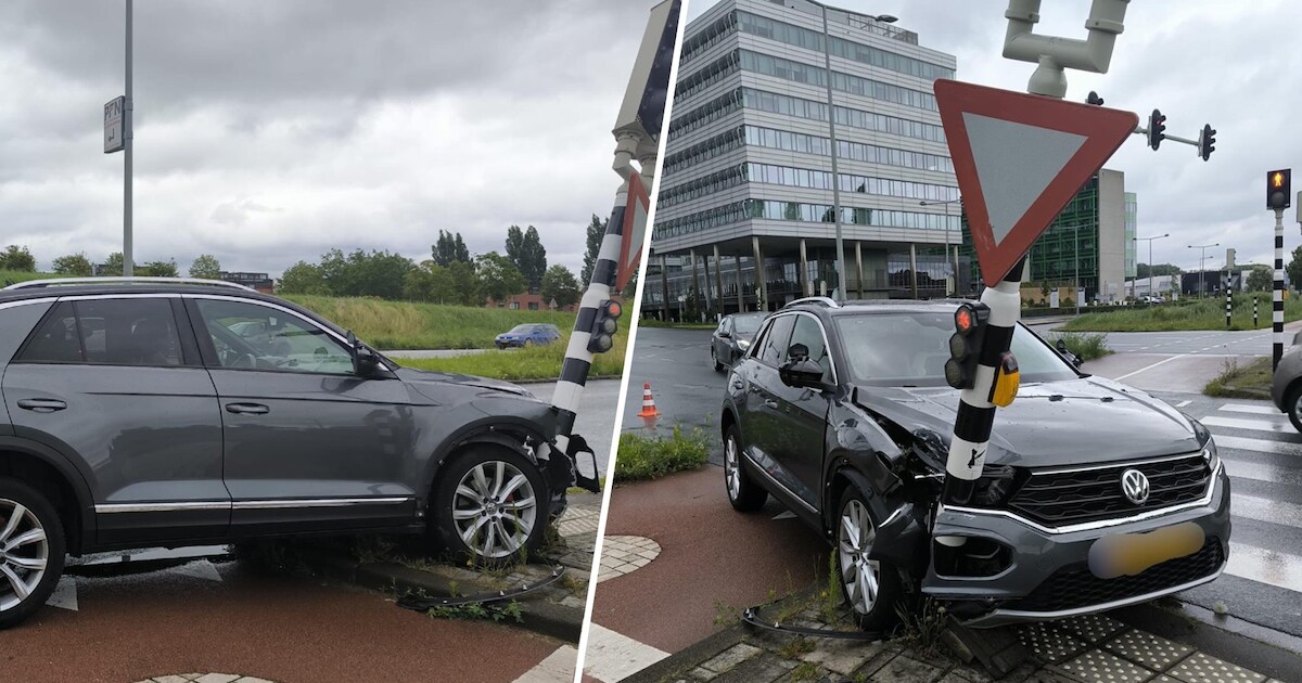 Leerling ramt verkeerslicht tijdens eerste rijles, instructeur ...