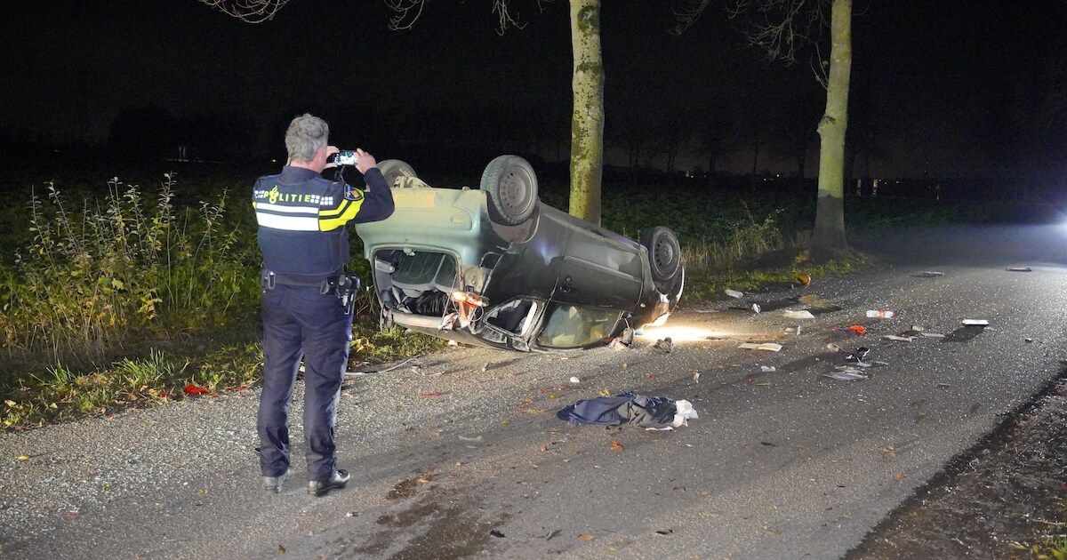 Auto knalt tegen een boom en belandt ondersteboven op de weg in Hernen ...